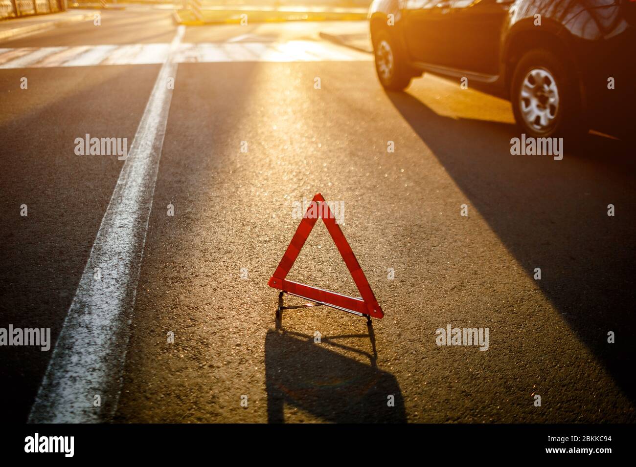The road triangle stands on the road. amid a broken car Stock Photo - Alamy