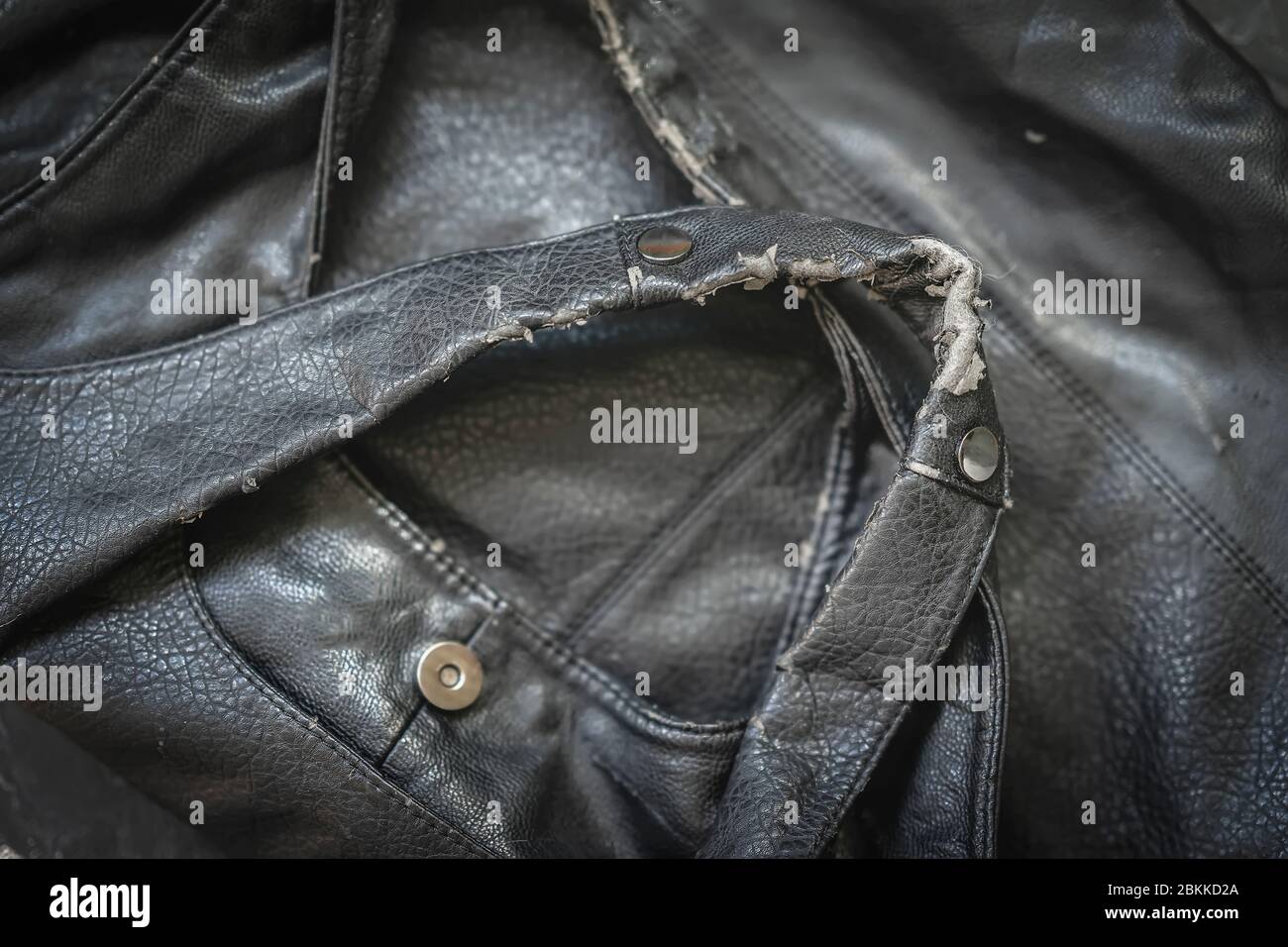 Old, crumpled and dirty leatherette bag, bag handles closeup, texture ...