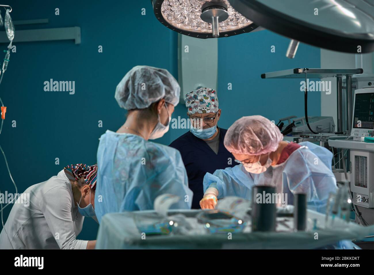 Group of surgeons in operating theater. Medical team performing surgery ...
