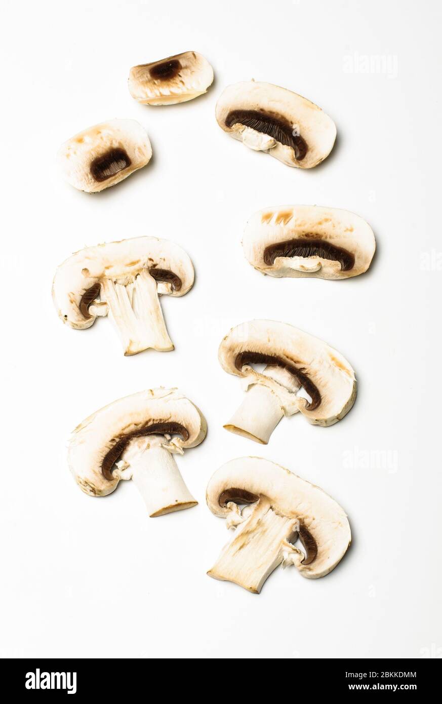 Raw champignon mushroom slices on the white background Stock Photo - Alamy