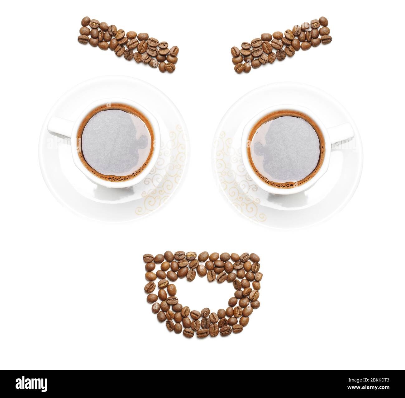Funny face arranged from coffee beans and mugs isolated on the white ...