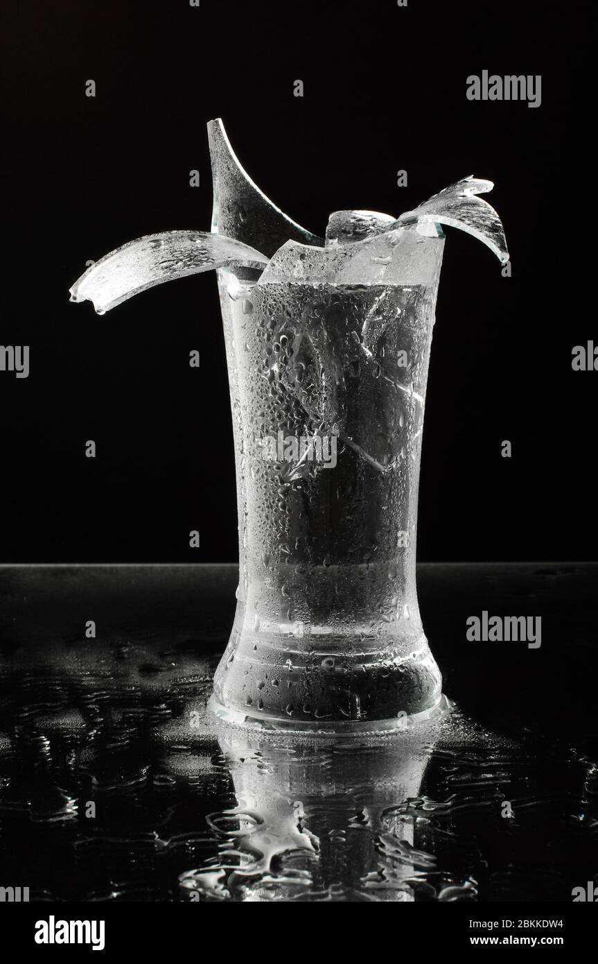 Broken glass fragments still life isolated on the black background ...