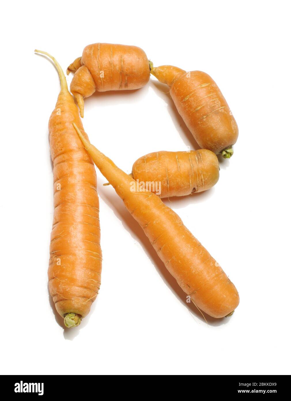 Alphabet letter R arranged from fresh organic carrots isolated on the ...
