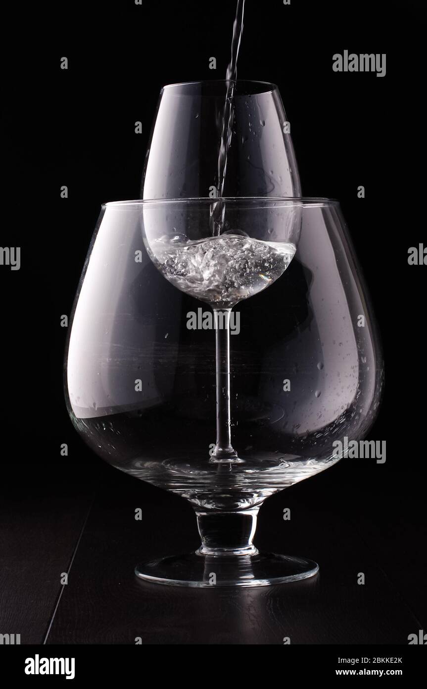 Wine glass in bigger wine glass isolated on the black background Stock ...