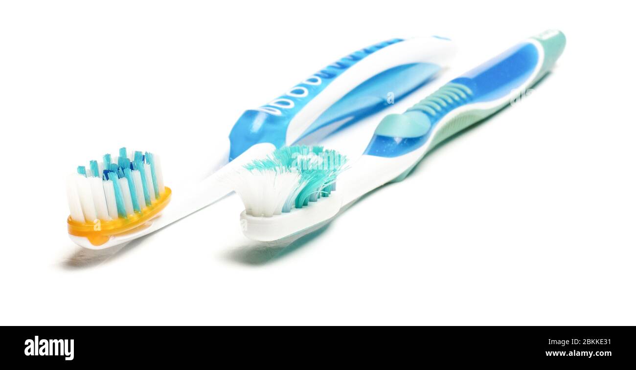 Old and new toothbrushes side by side isolated on the white background ...