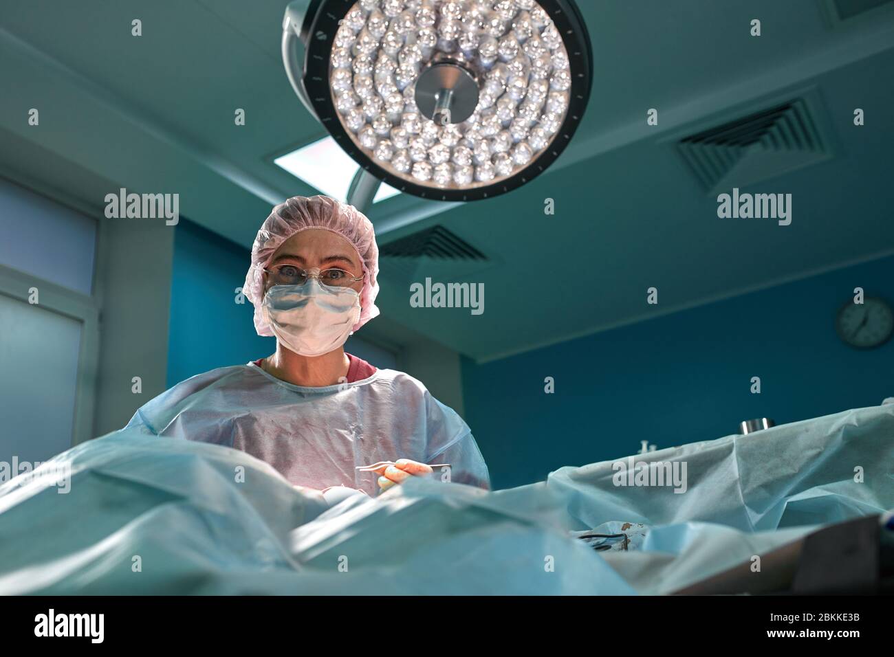Close up portrait of young female surgeon doctor wearing protective ...