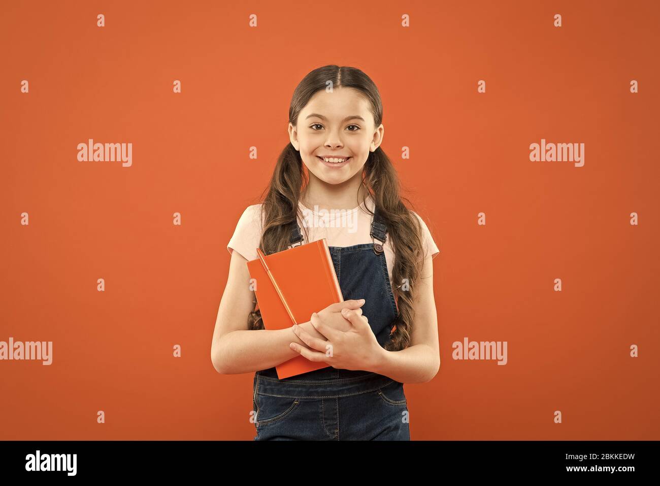 favorite book. happy little girl with notebook. reading book ...