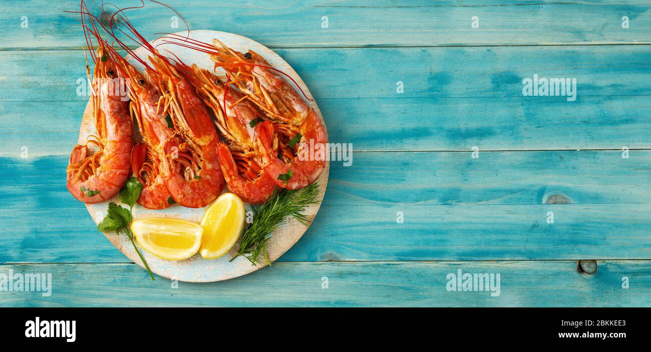 Top view of red big prawns on light blue background Stock Photo - Alamy