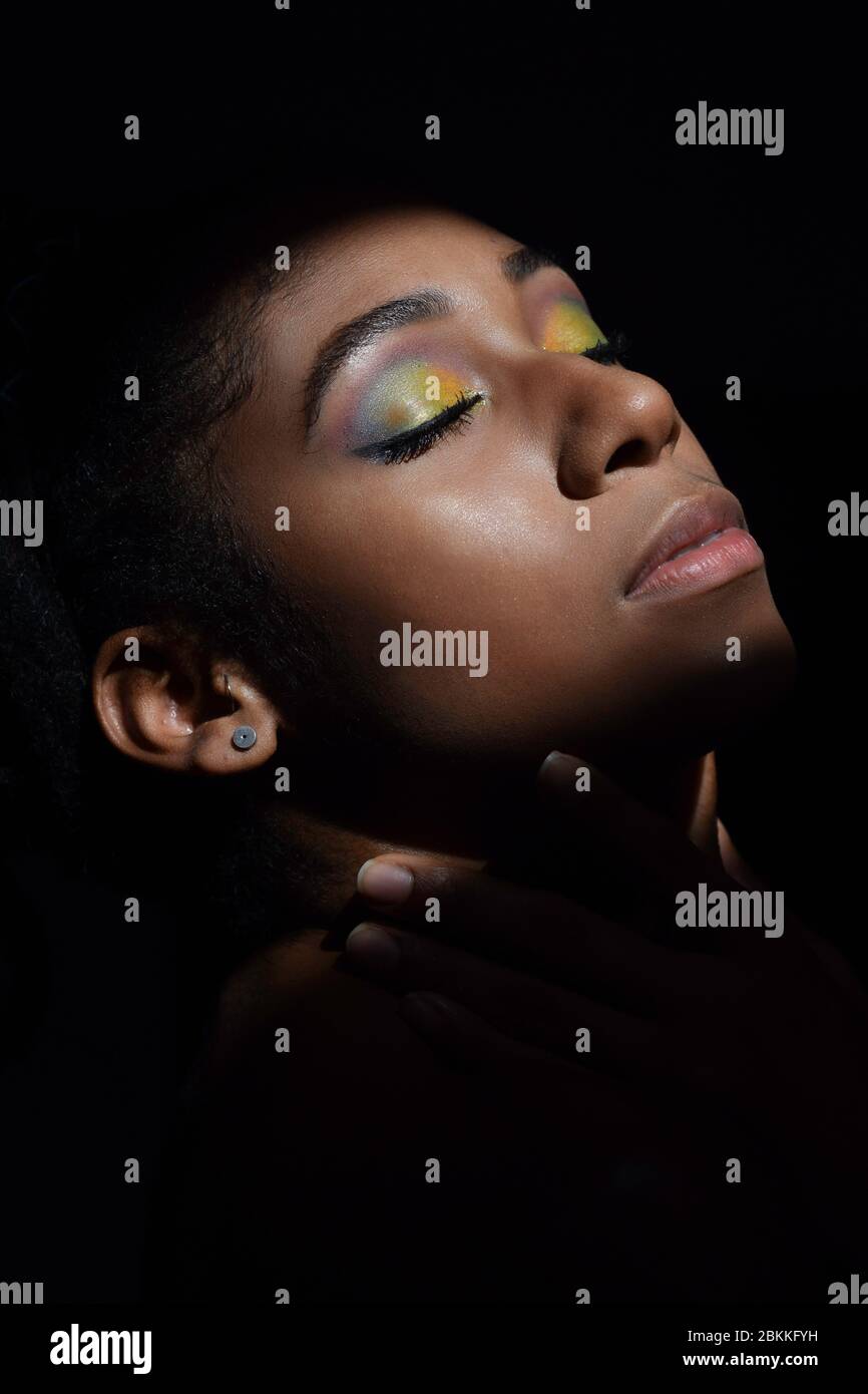 Interior chiaroscuro portrait of young black woman Stock Photo - Alamy