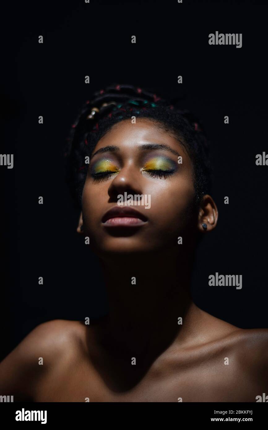 Interior chiaroscuro portrait of young black woman Stock Photo - Alamy