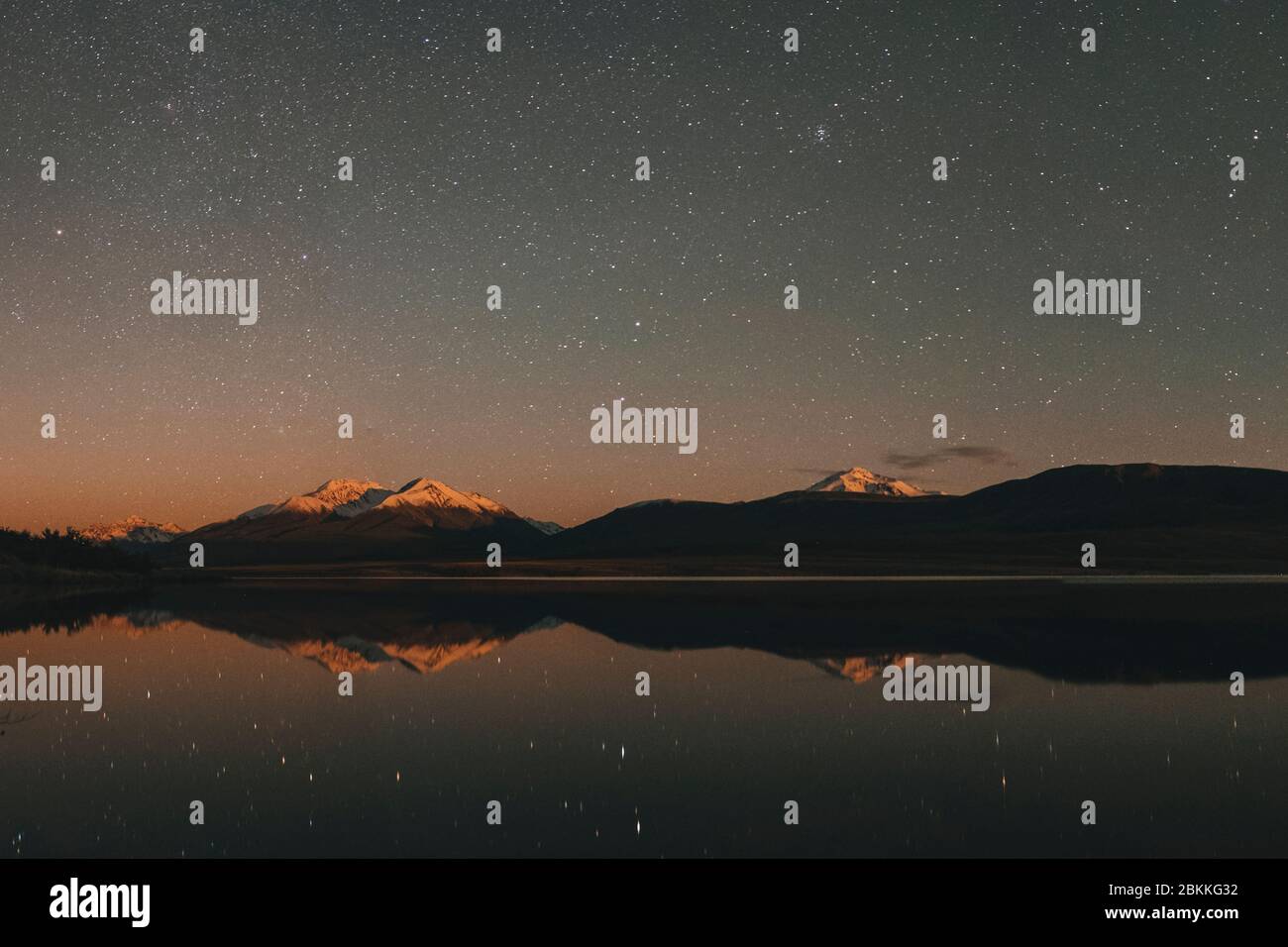 Panoramic reflection view of the Southern Alps with moon glow during ...