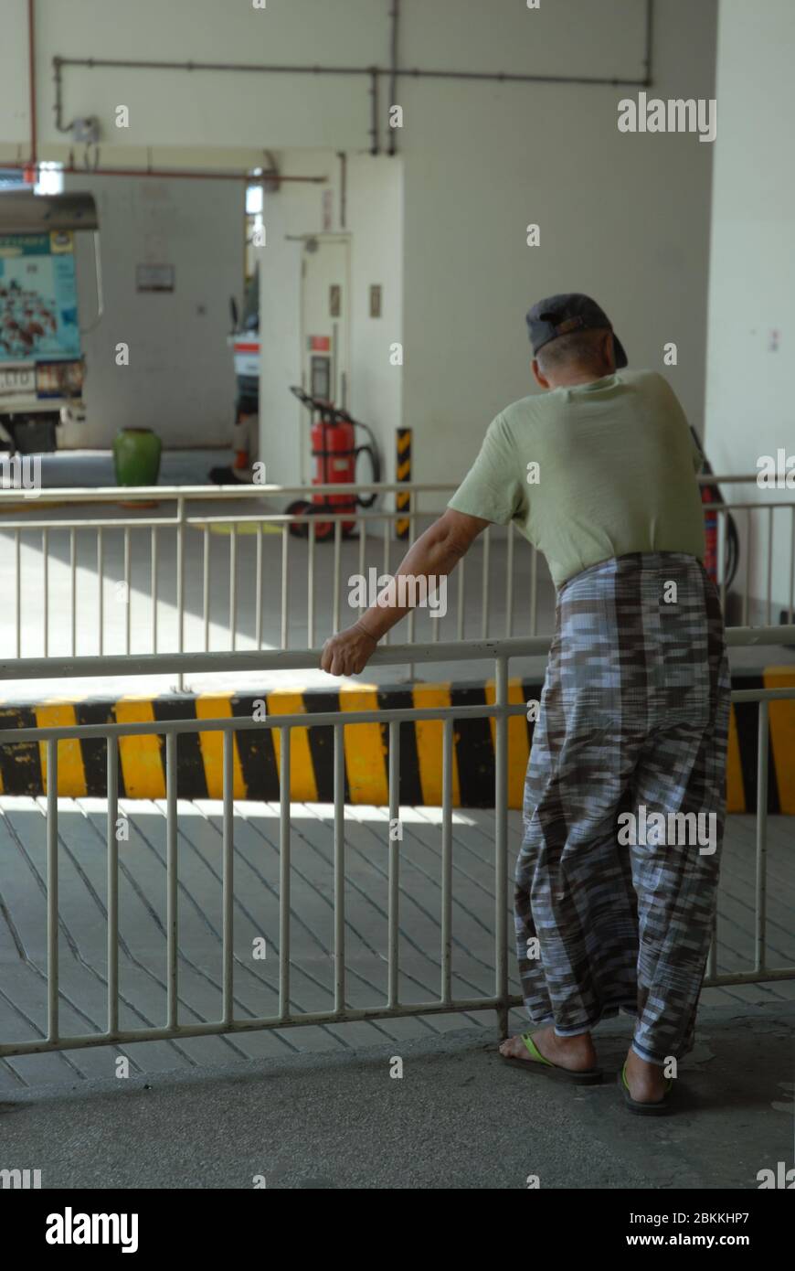 Old man leaning on a metal rail, Yangon, Myanmar, Asia Stock Photo - Alamy