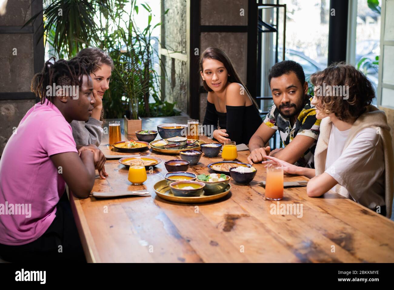 Multi-ethnic students meeting in an asian style cafe Stock Photo - Alamy