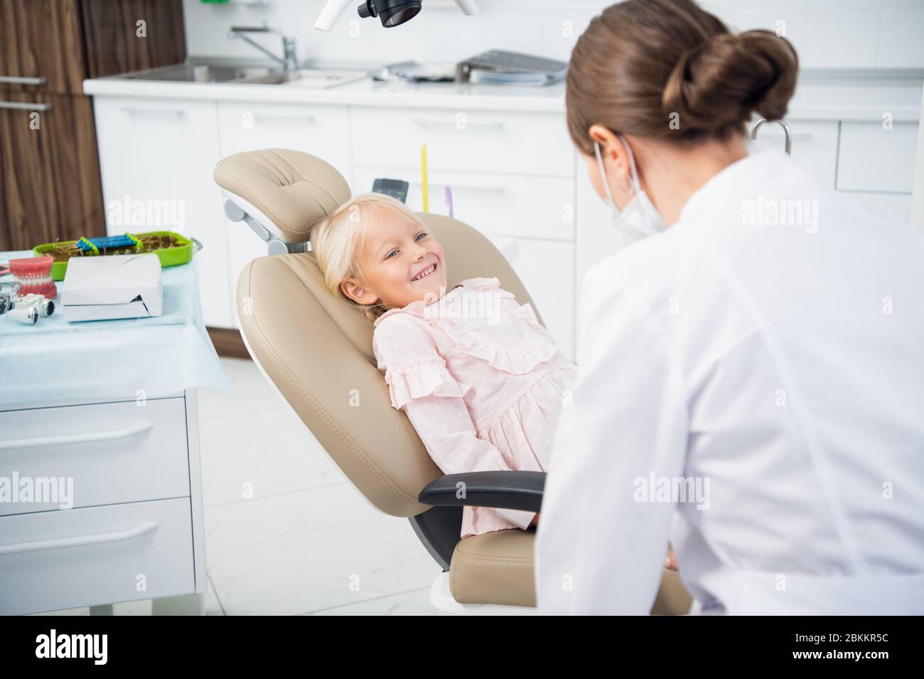 The doctor treating small child's teeth in the dental clinic Stock ...