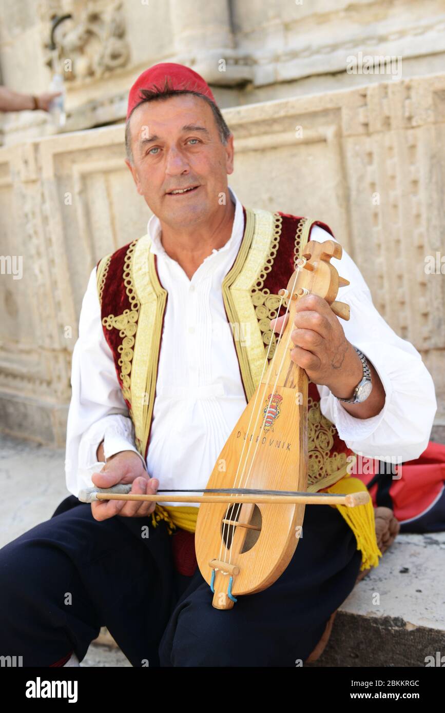 A Croatian man playing the traditional Lijerica musical instrument ...