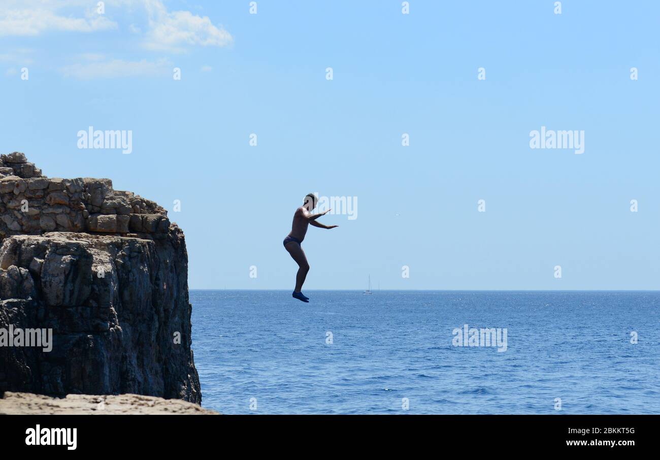 Jumping into the sea from the coastal cliffs of Lokrum island near ...