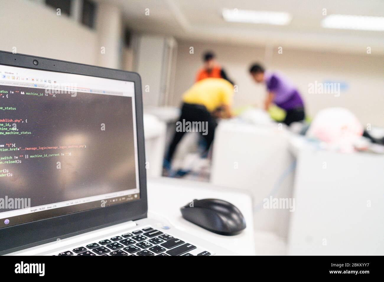 Close-up laptop display programming on office desk with blured business ...