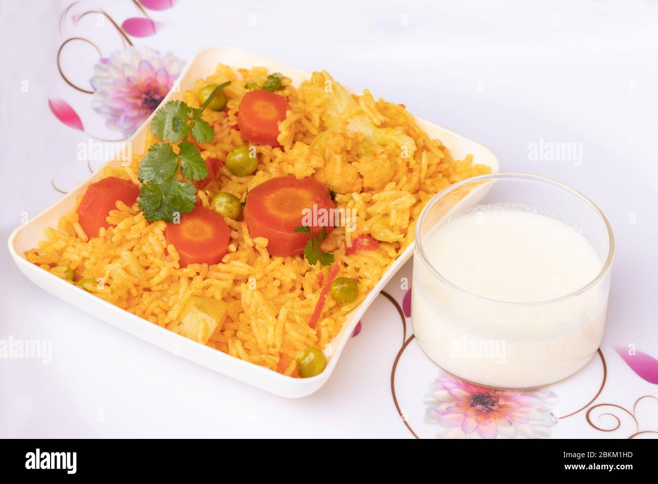 Basmati rice vegetable pulao served in plate with curd Stock Photo - Alamy