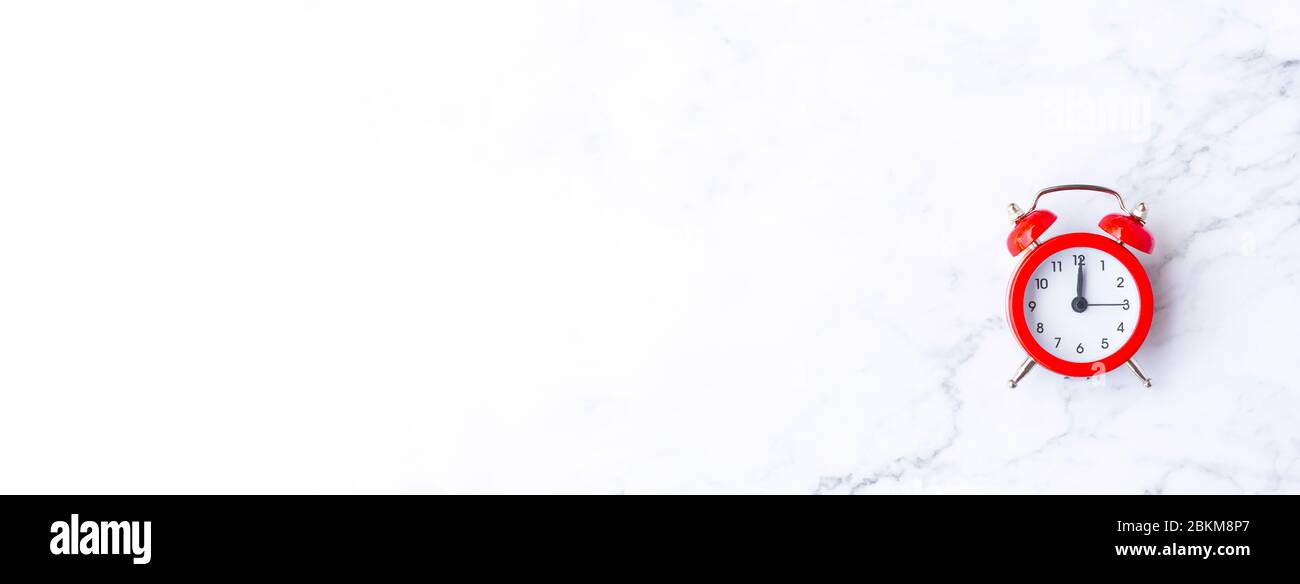 50s vintage red clock on luxury marble textured background office table ...