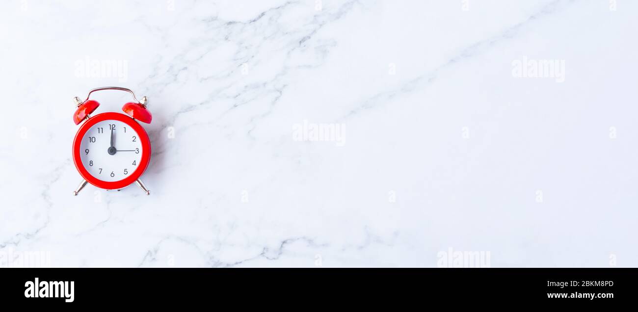 50s vintage red clock on luxury marble textured background office table ...