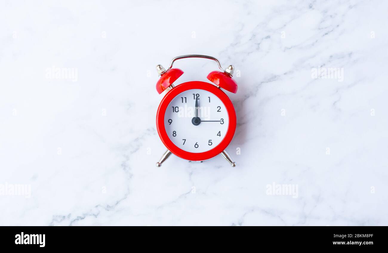 50s vintage red clock on luxury marble textured background office table ...