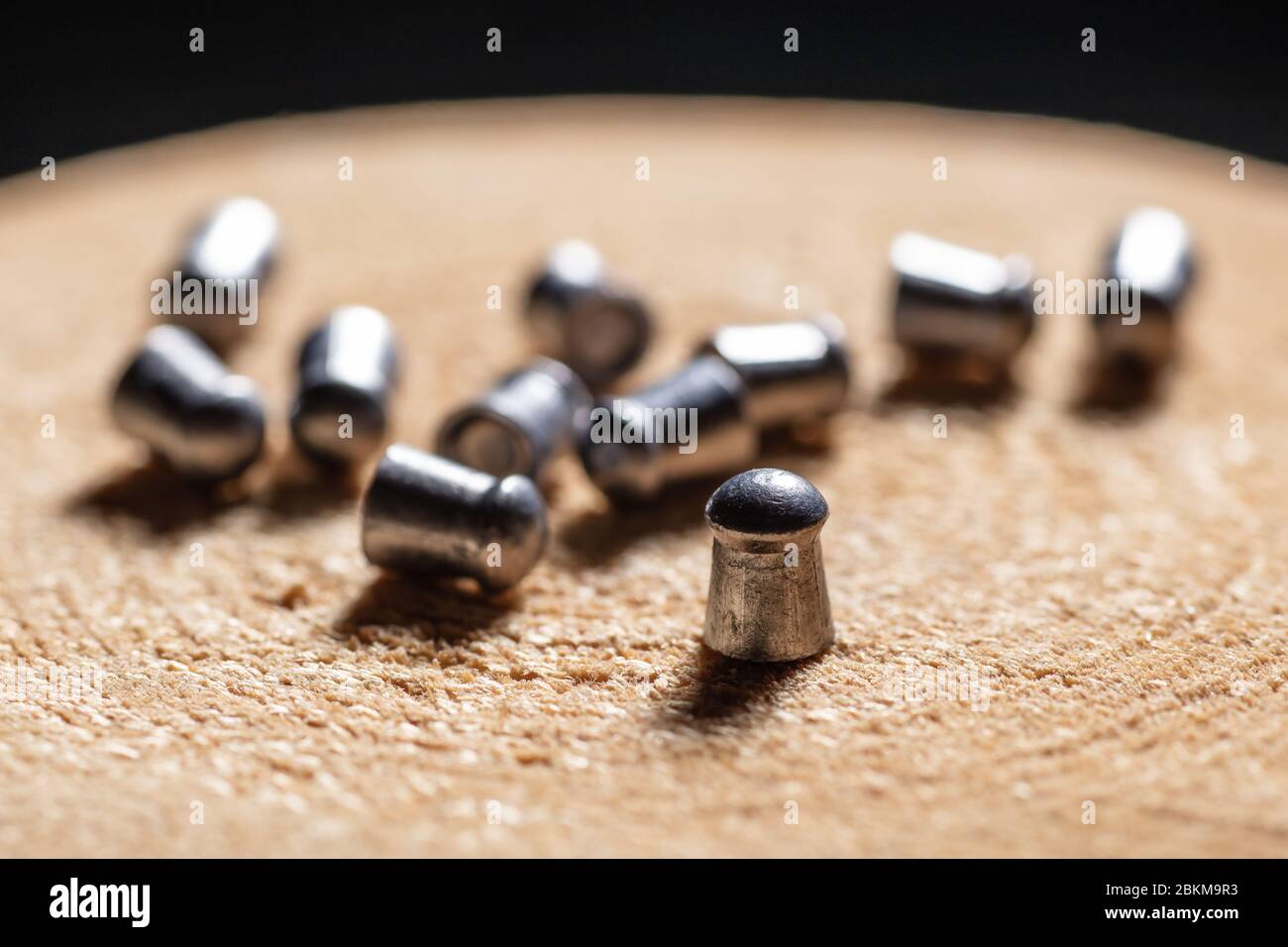 Lead bullets for an air rifle on a tree cut Stock Photo - Alamy