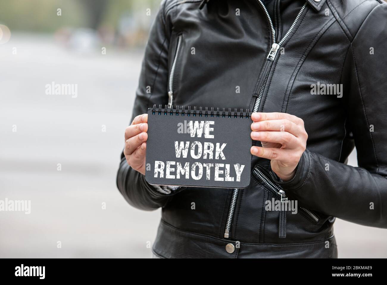 WE WORK REMOTELY. Text on black background. Working from home concept ...