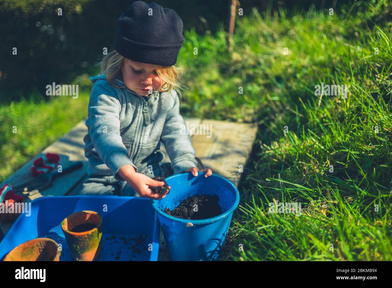 Boy planting seeds hi-res stock photography and images - Alamy