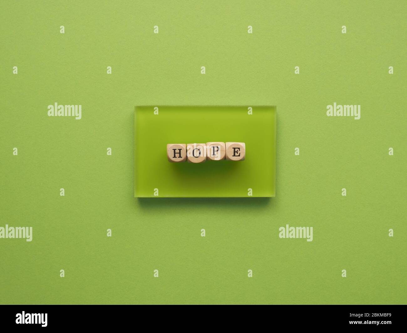 Wooden blocks with the word hope on a green background, green is the ...