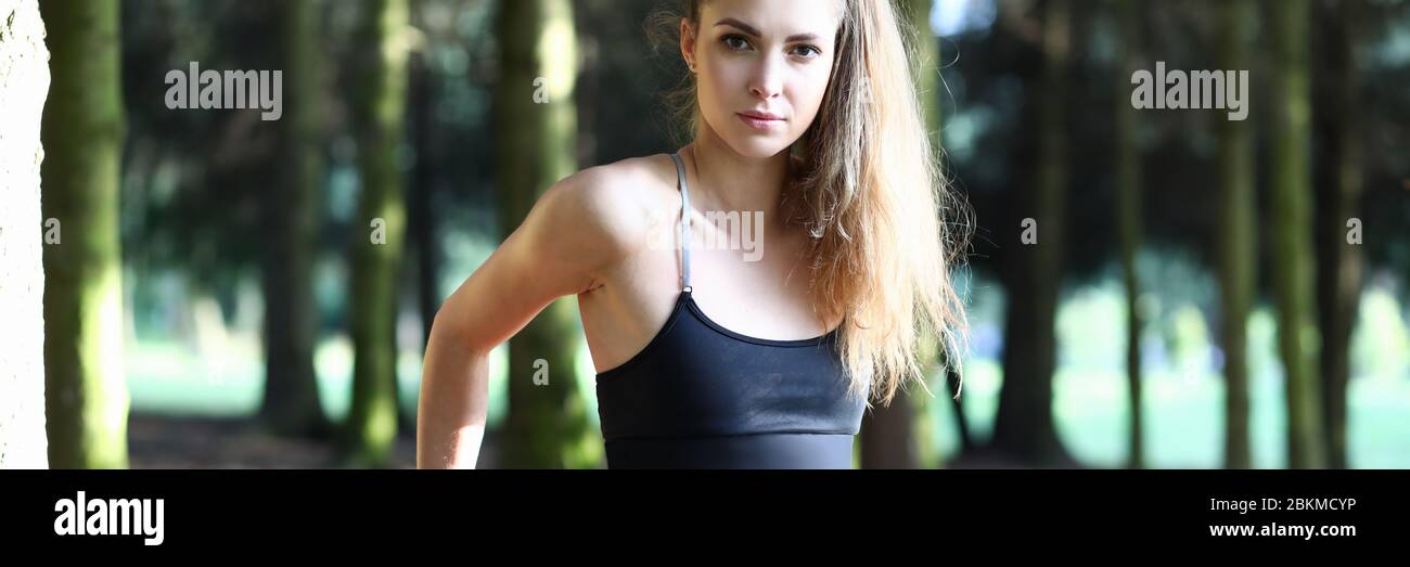 Girl doing exercises in park, leaning on bench Stock Photo - Alamy