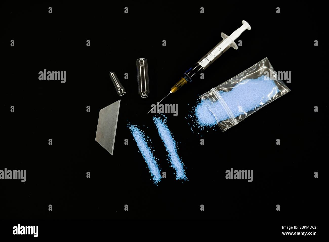 blue drugs line with syringe, broken ampoule on black background Stock ...
