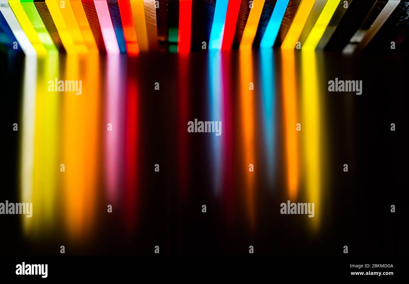 light through Stack of different colours Cast Acrylic Sheet on black ...