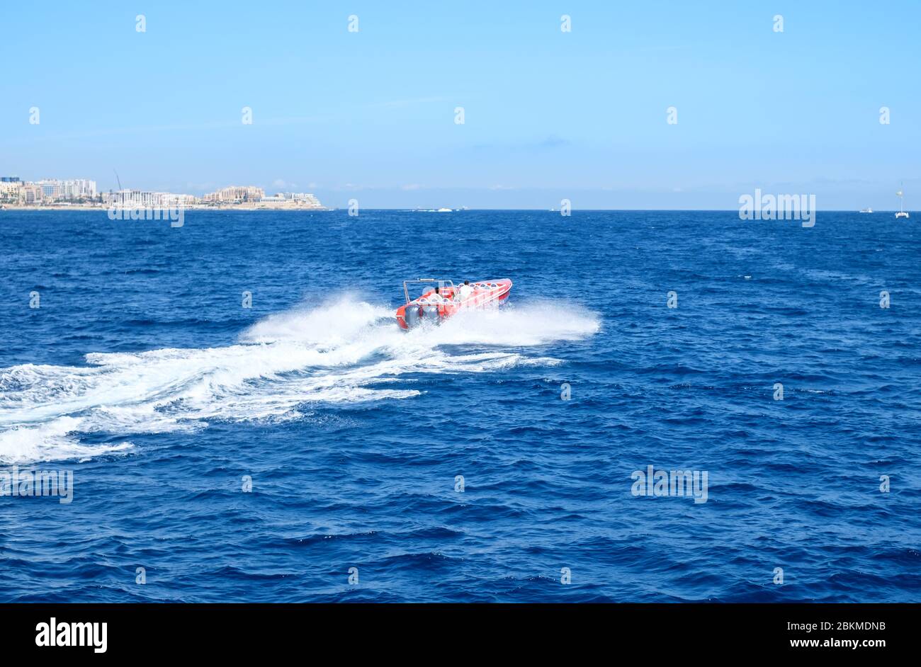 Red speed boat on blue water Stock Photo - Alamy