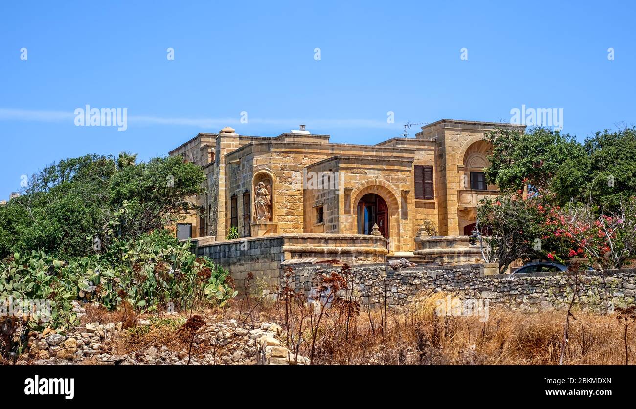 The facade of the traditional maltese house in Gozo made of limestone ...