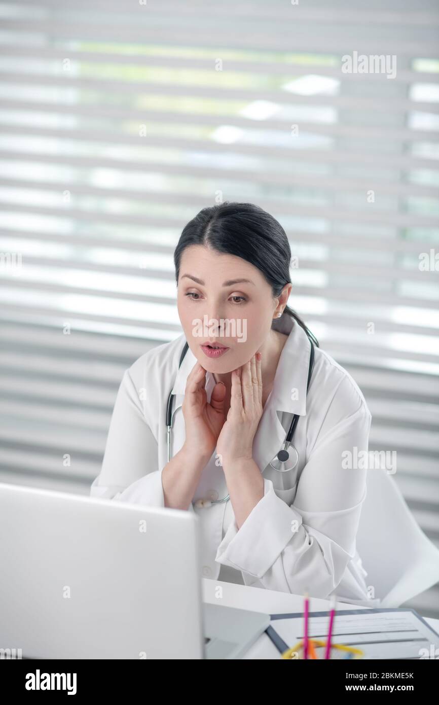 Smart female doctor talking on laptop screen Stock Photo - Alamy
