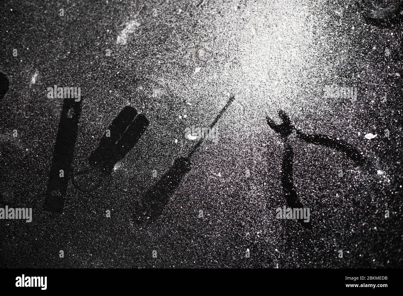 Traces of tools on a black table dusted with white dust Stock Photo - Alamy