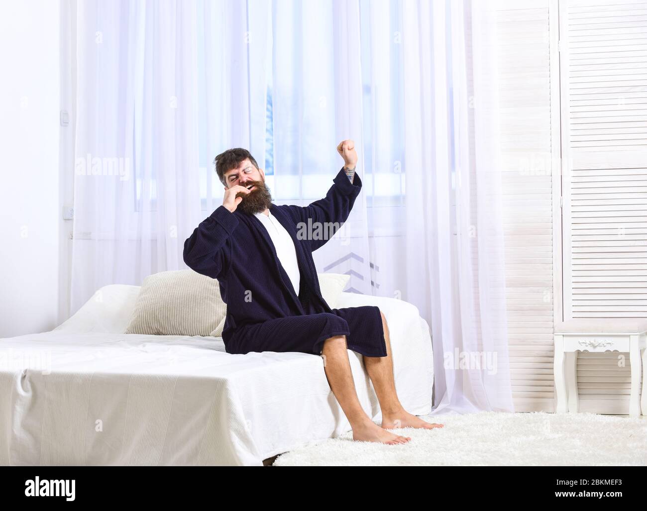 Guy on sleepy face yawning and stretching. Awakening concept. Man in ...