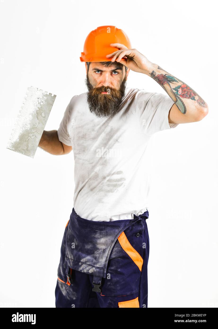 Bearded repairman with serious face and dirty boilersuit, white ...