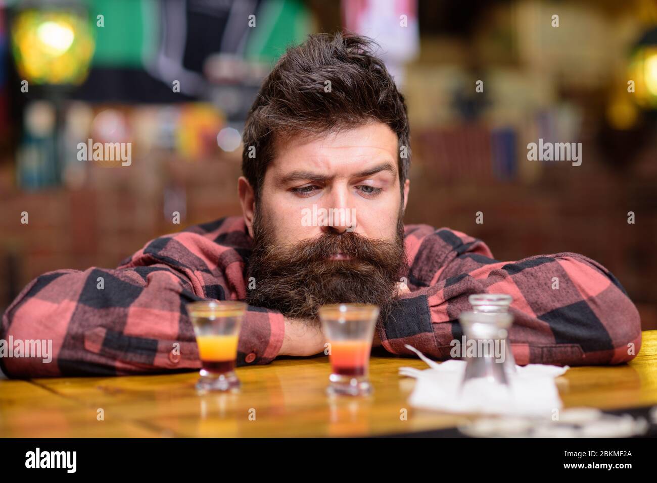 Depression and alcoholism concept. Depressed and sad man sit alone in ...