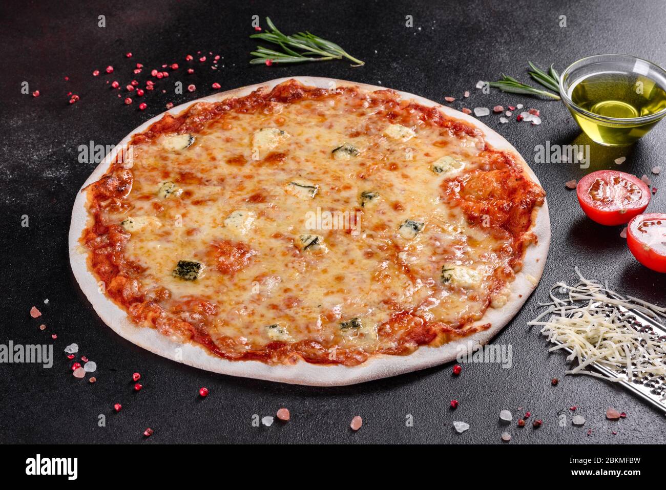 Delicious fresh oven cooked pizza four cheeses on cozy restaurant table ...