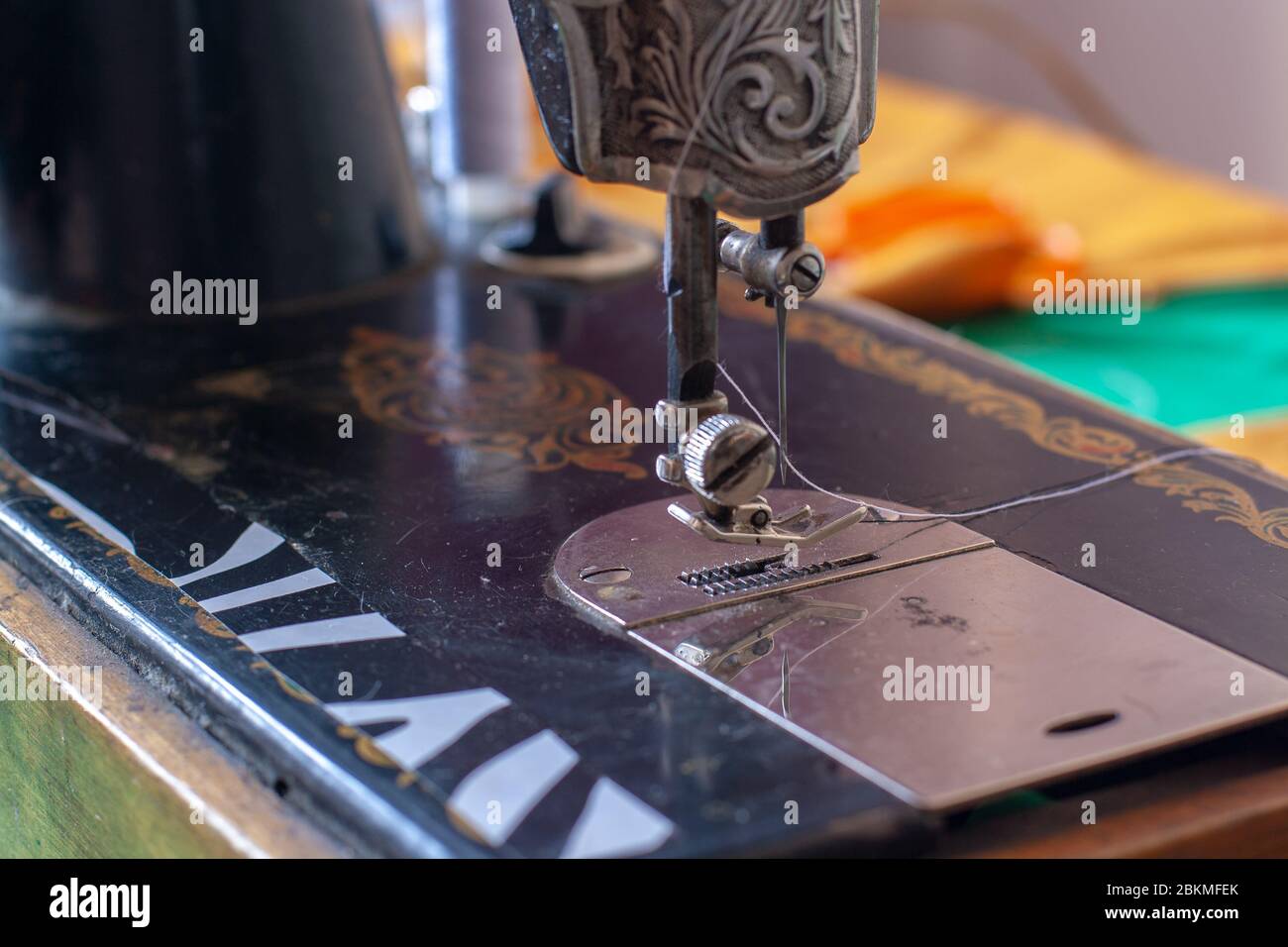 Old retro sewing machine with a needle and inserted white thread ...
