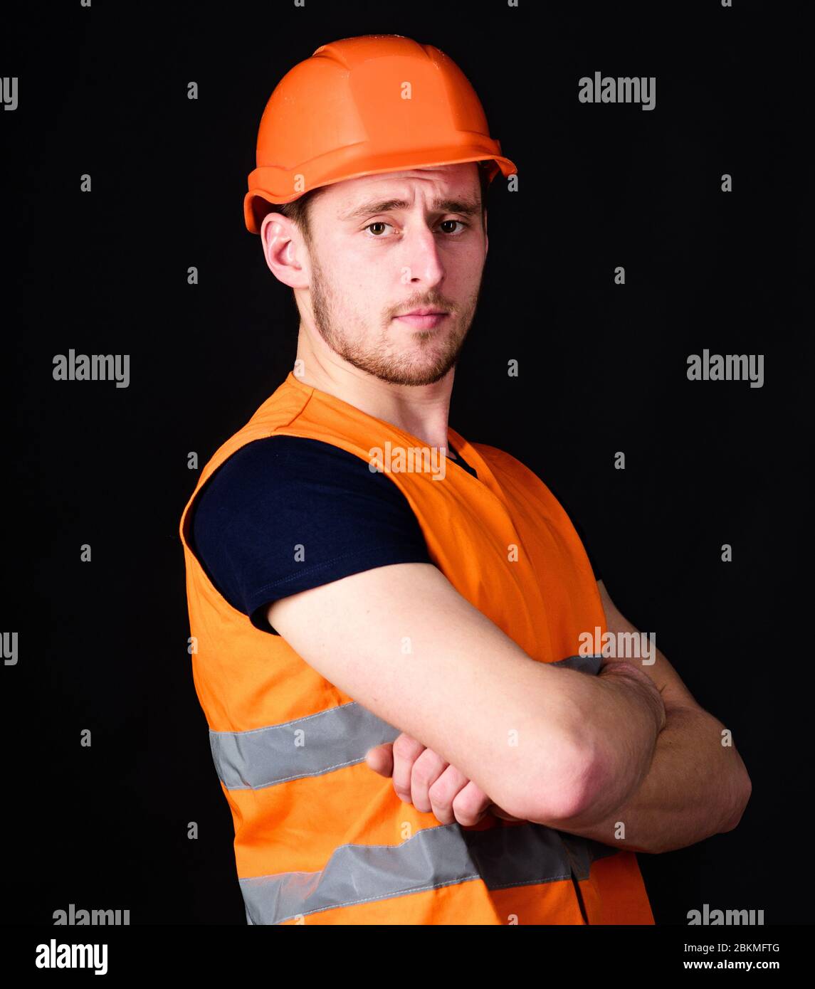 Strong builder concept. Builder in helmet posing confidently. Man in ...