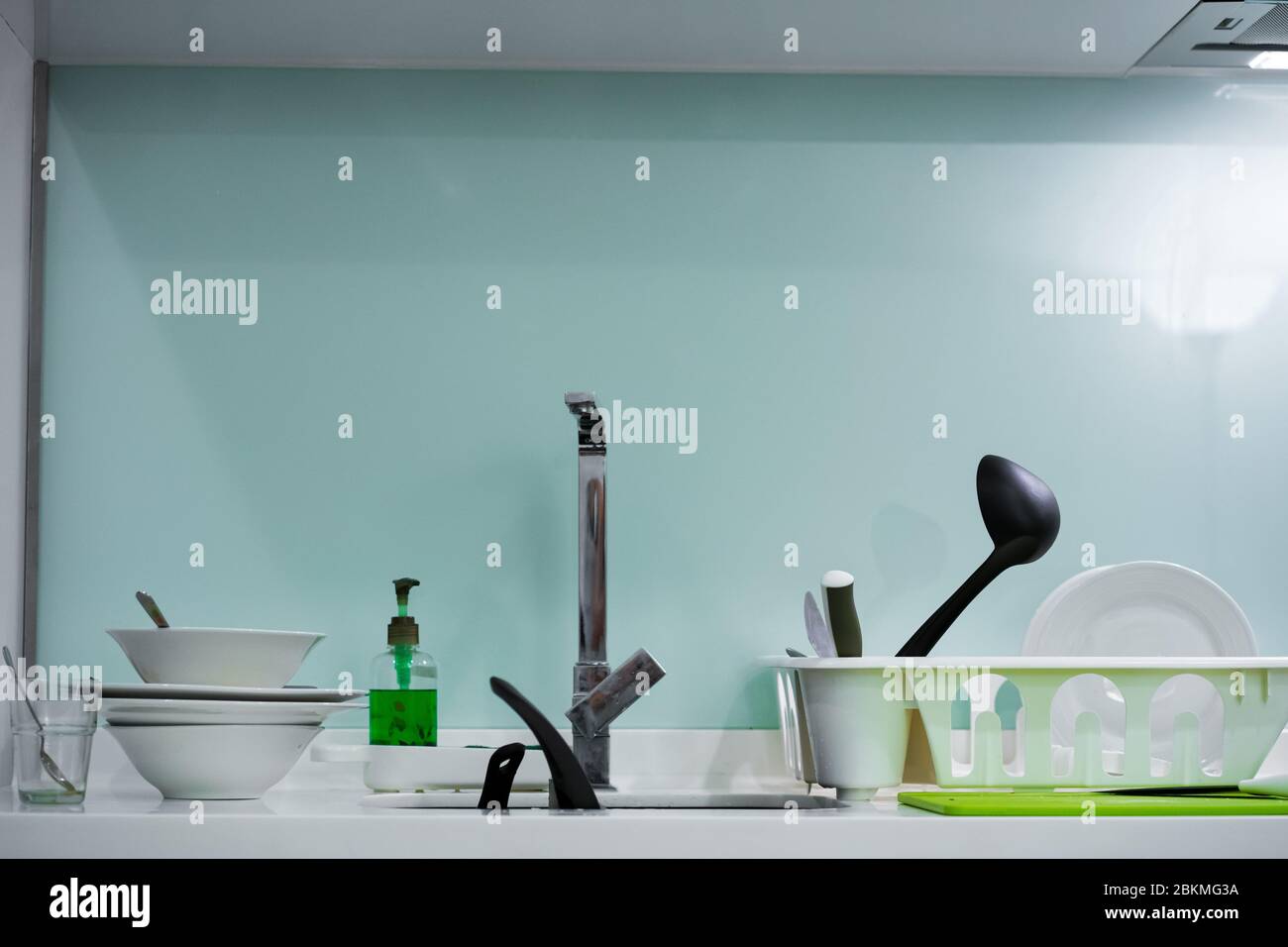 A mountain of dirty dishes in the kitchen sink. Mess in the house Stock ...