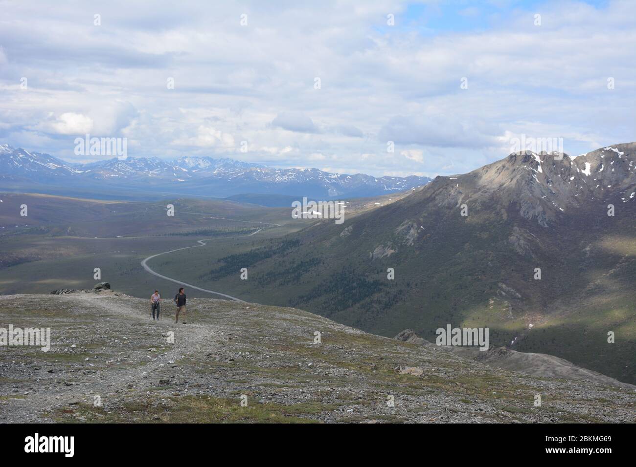 Two hikers tackle a ridge for views across a huge valley to the Alaska ...