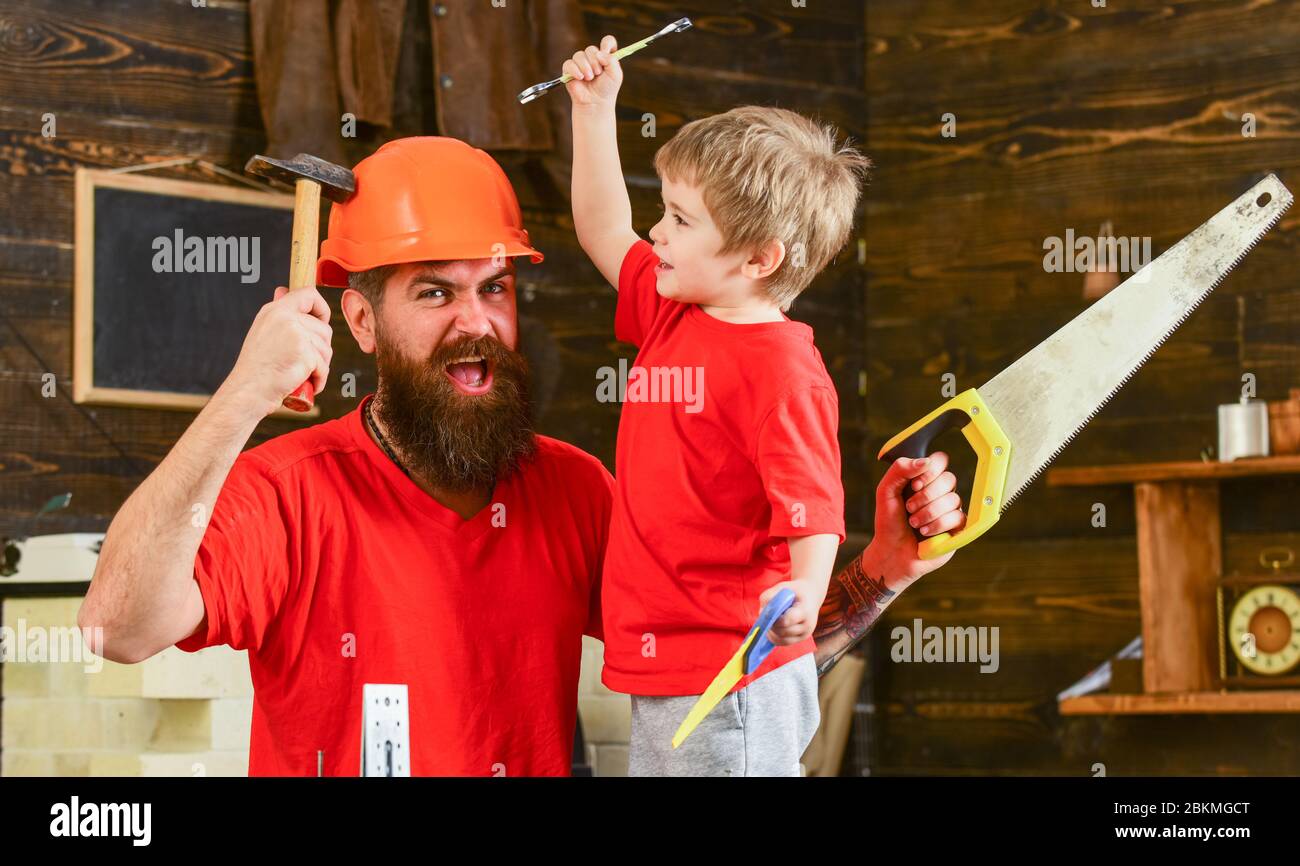 Fatherhood concept. Boy, child cheerful holds spanner wrench, learning ...