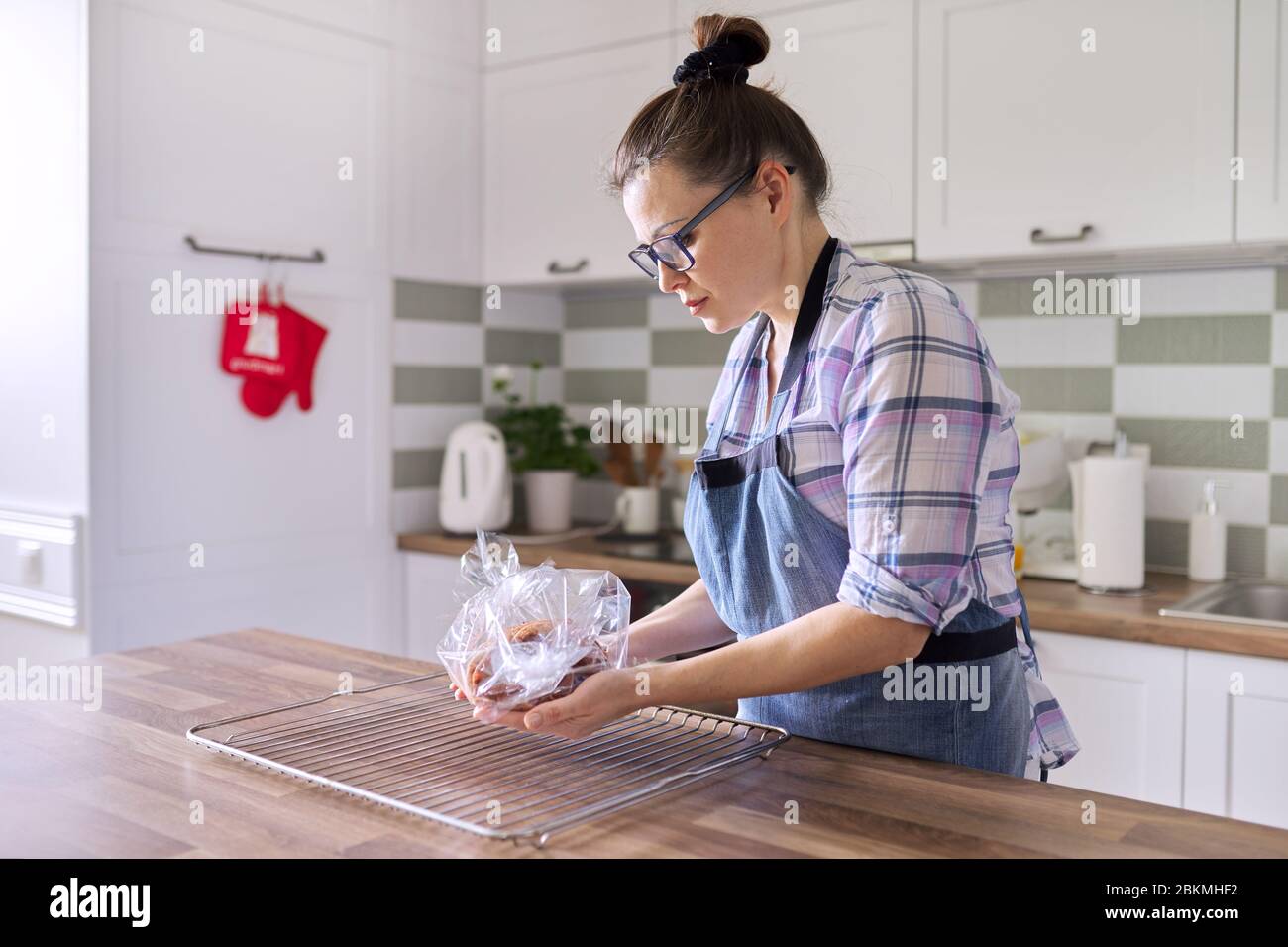 Woman packs pork leg marinated with spices in baking sleeve Stock Photo ...