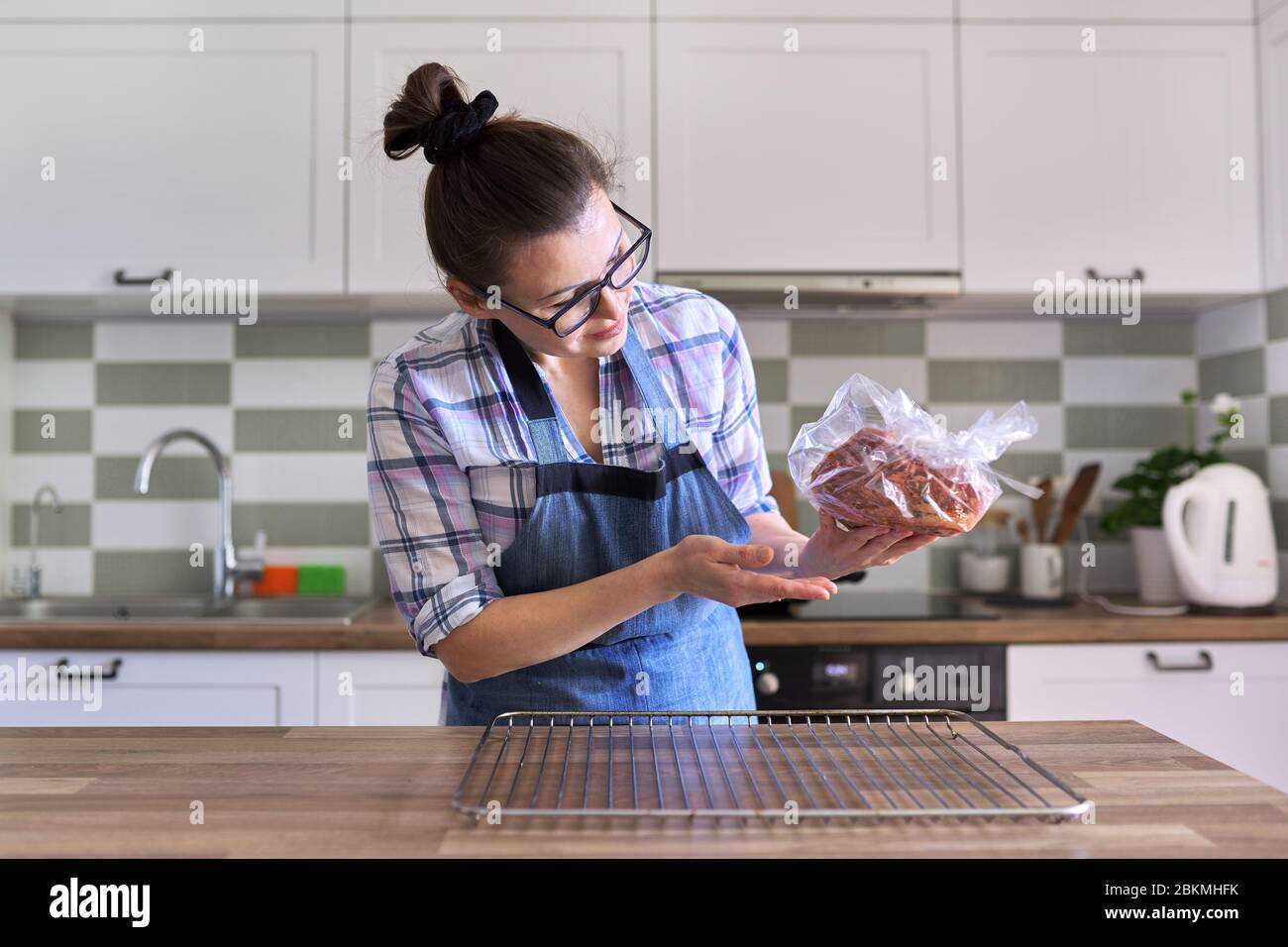 Woman packs pork leg marinated with spices in baking sleeve Stock Photo ...
