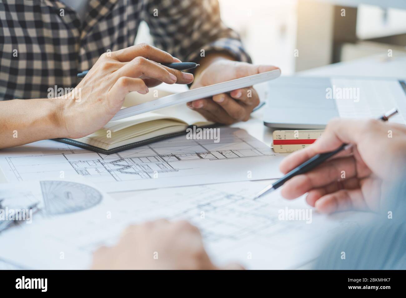 Cooperation Corporate designers in the office are working on a new project Planning blueprint ...