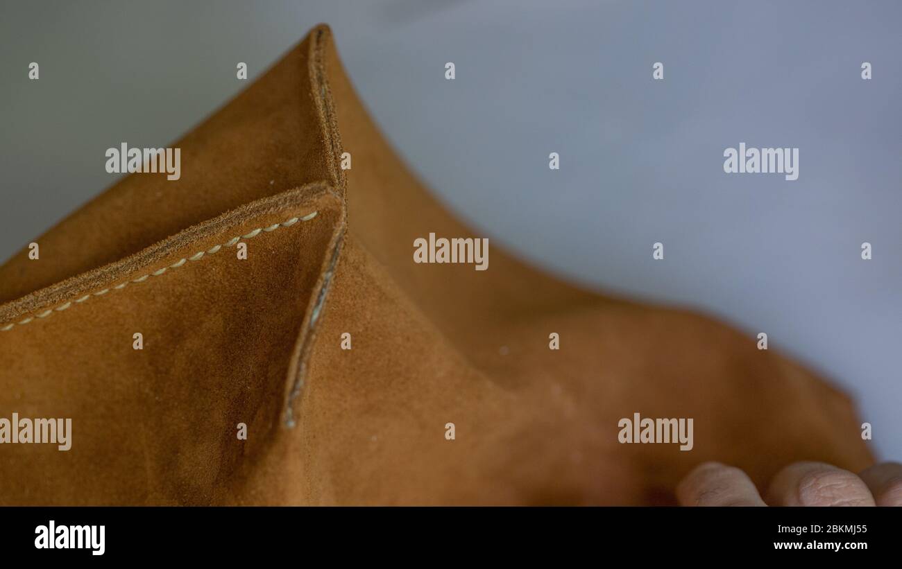 Handmade handicraft leather bag sewing process. Leather workshop ...