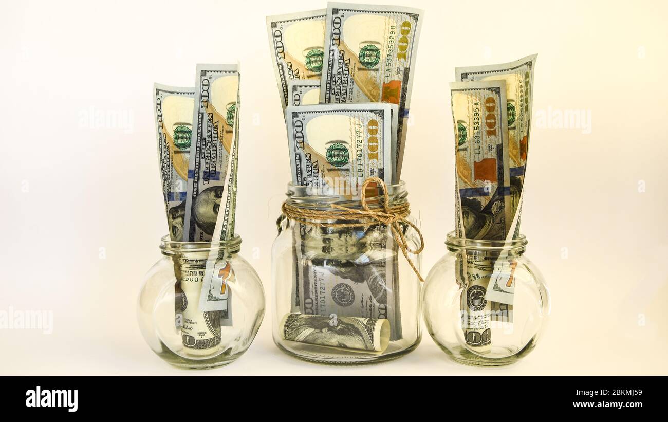Glass jars filled with dollar bills, savings inside glass jar, money ...